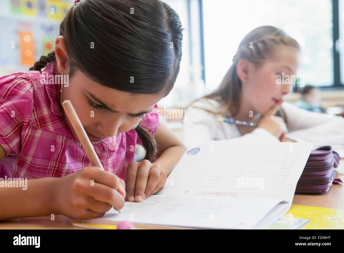 schoolgirls writing in notebooks, Munich, Bavaria, Germany Stock Photo ...