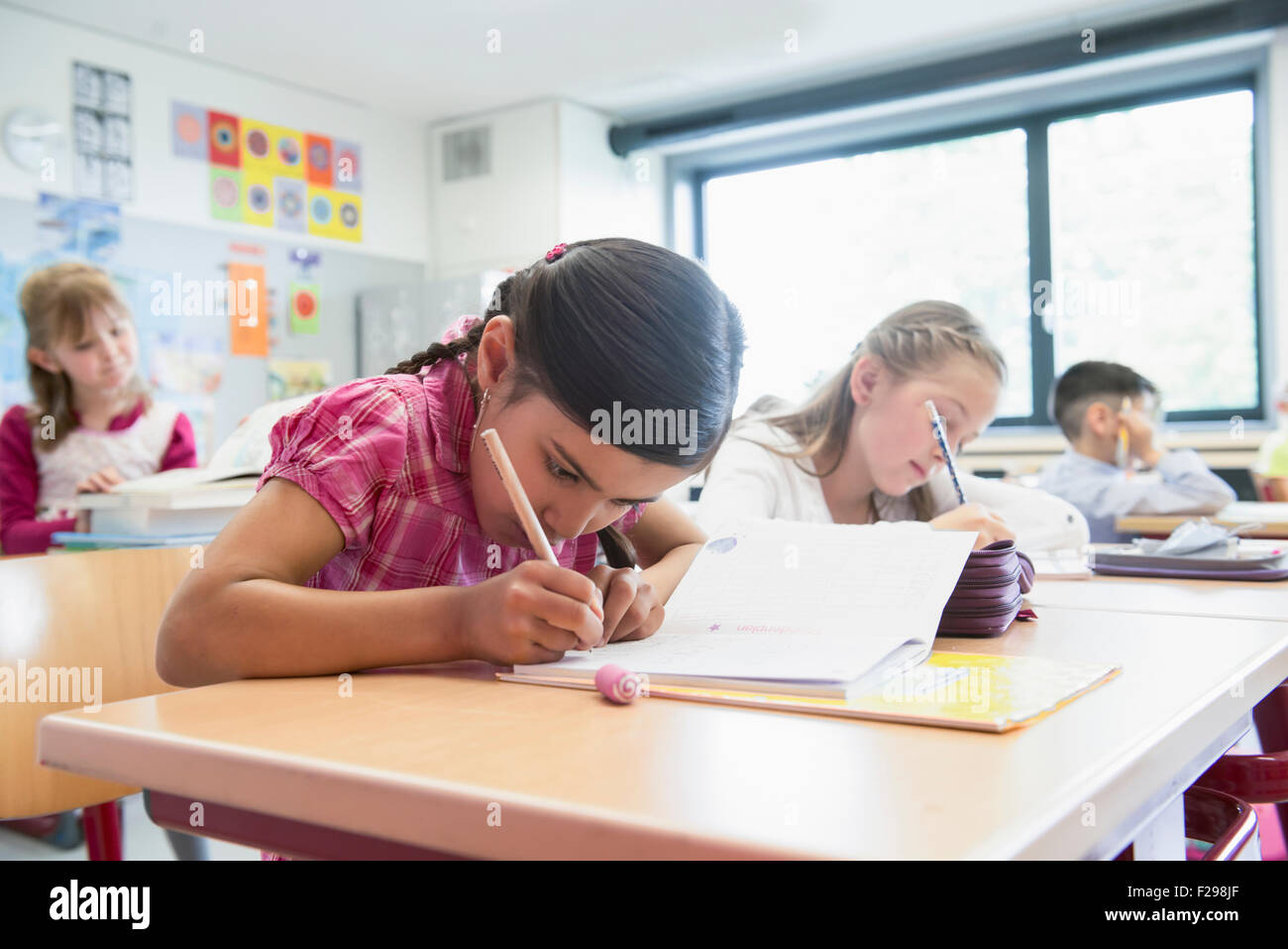 school students writing in notebooks, Munich, Bavaria, Germany Stock ...