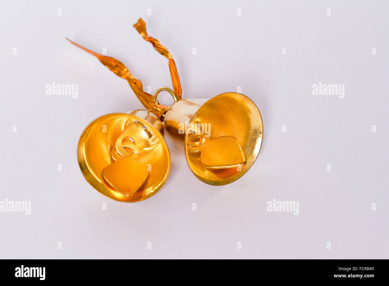 Two gold bell on white background Stock Photo - Alamy