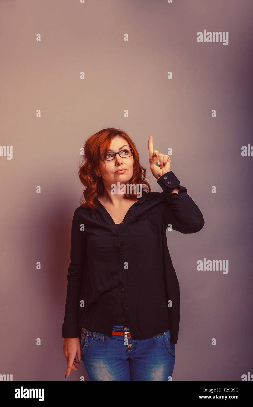 European-looking woman of 30 years is pointing in the direction Stock ...