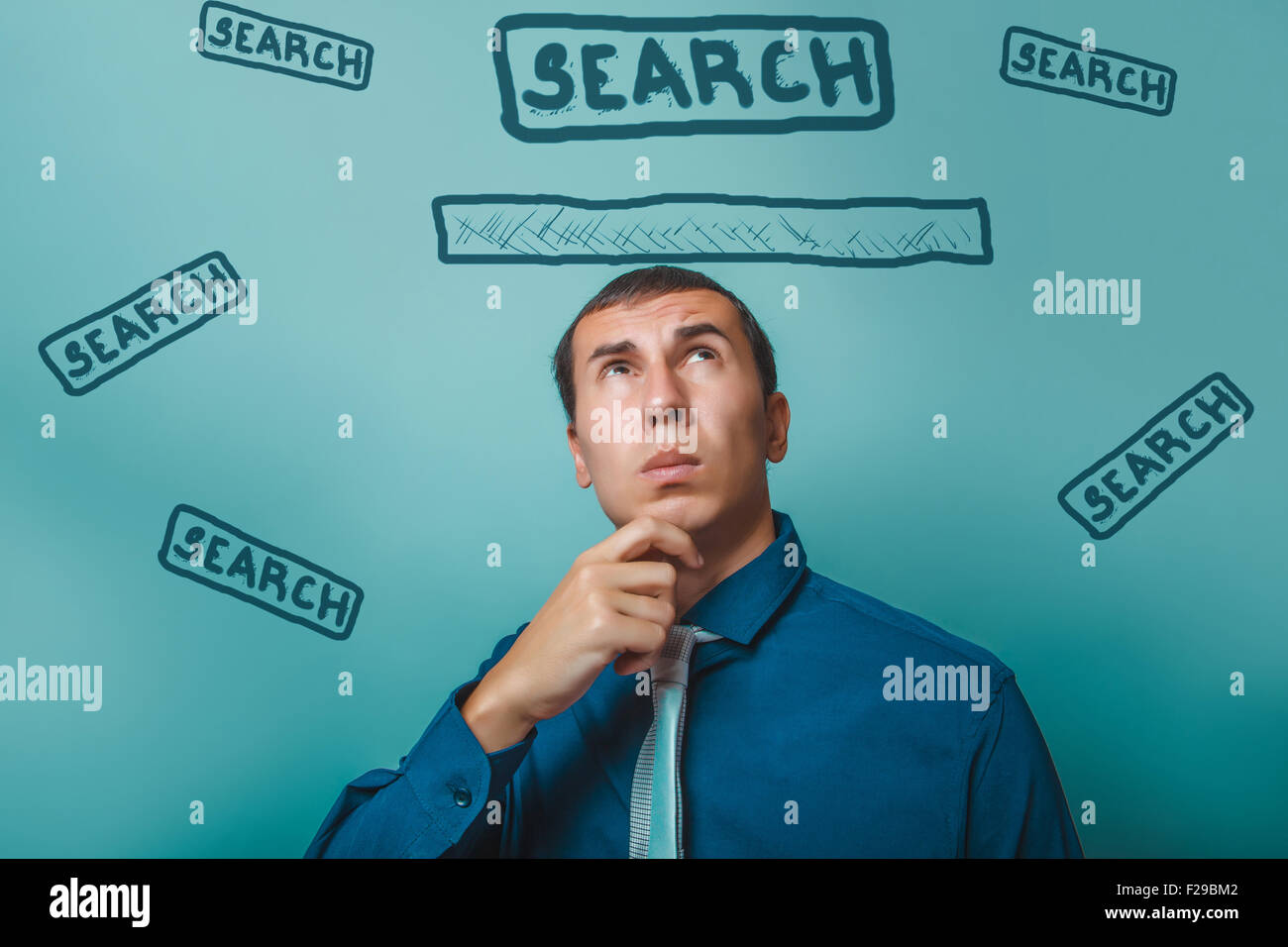 Man Male businessman thinking holding his chin looks up disguste Stock ...