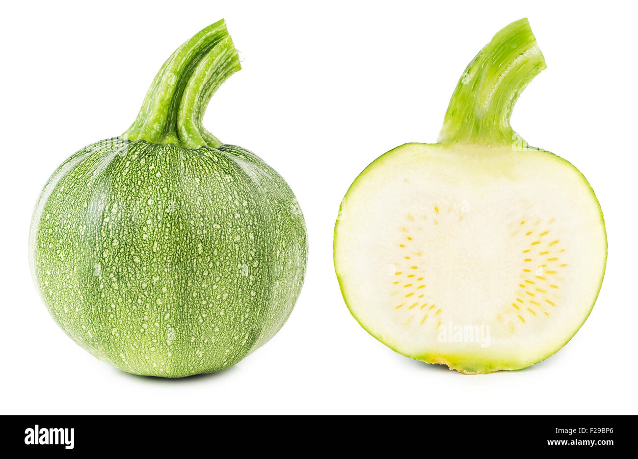 Fresh courgettes cut in half isolated on white background Stock Photo ...