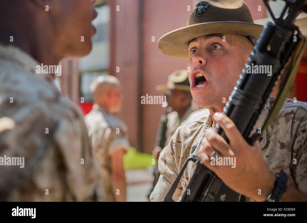 A U.S. Marine drill instructor motivates recruits during weapons drill ...