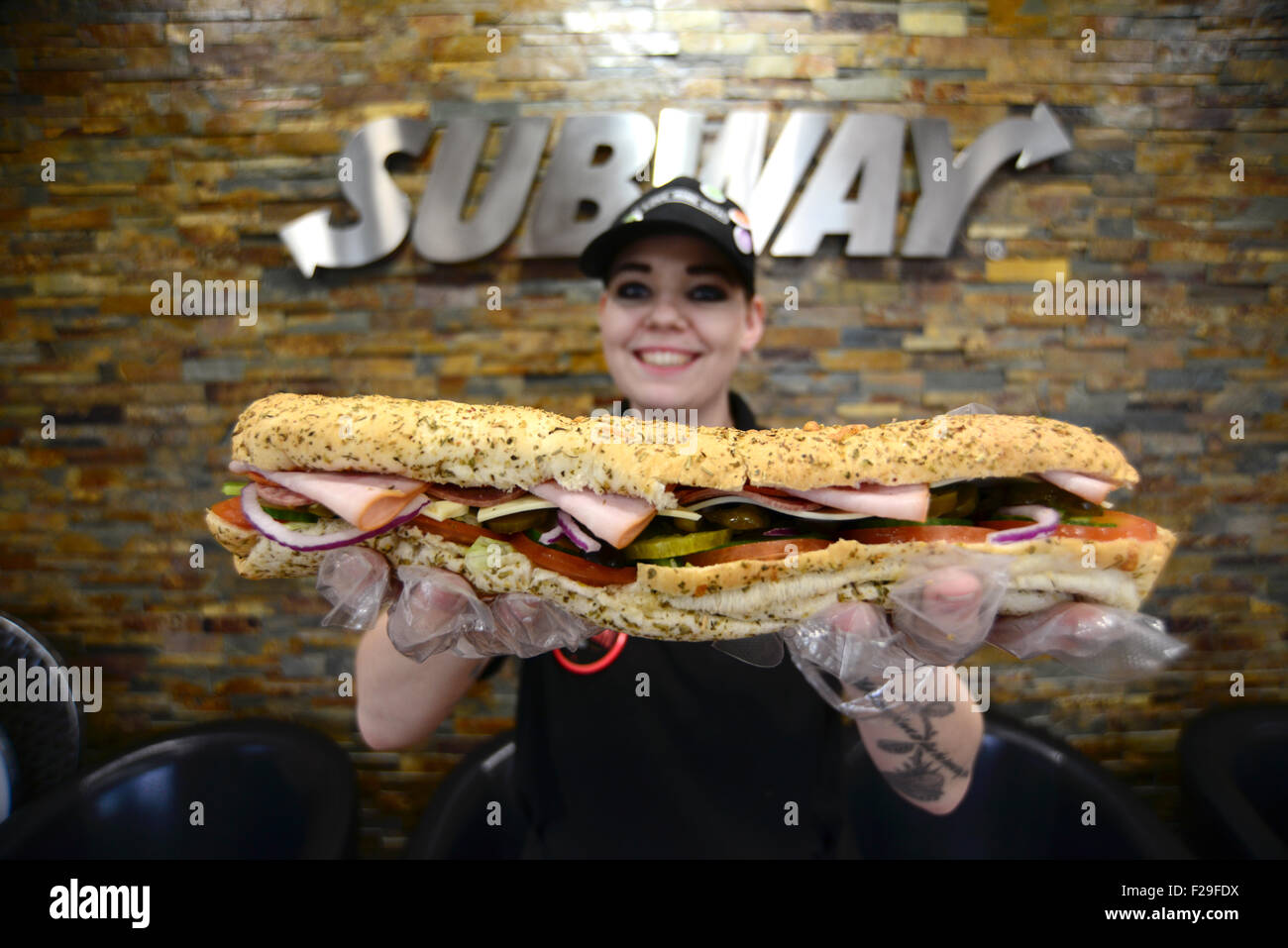 A Subway staff member holding a footlong sandwich. Picture: Scott ...