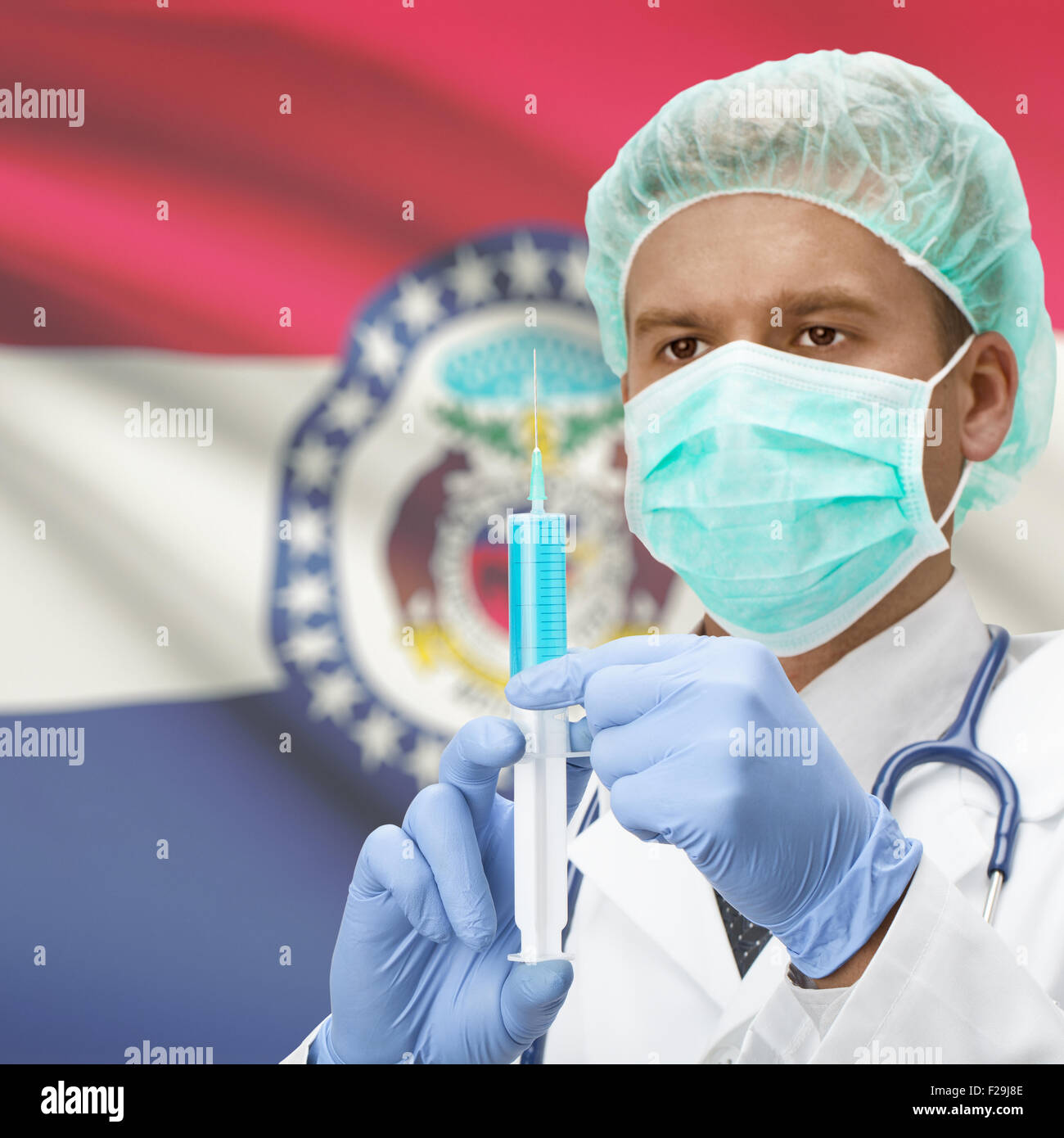 Doctor with syringe in hands and USA states flags on background series ...