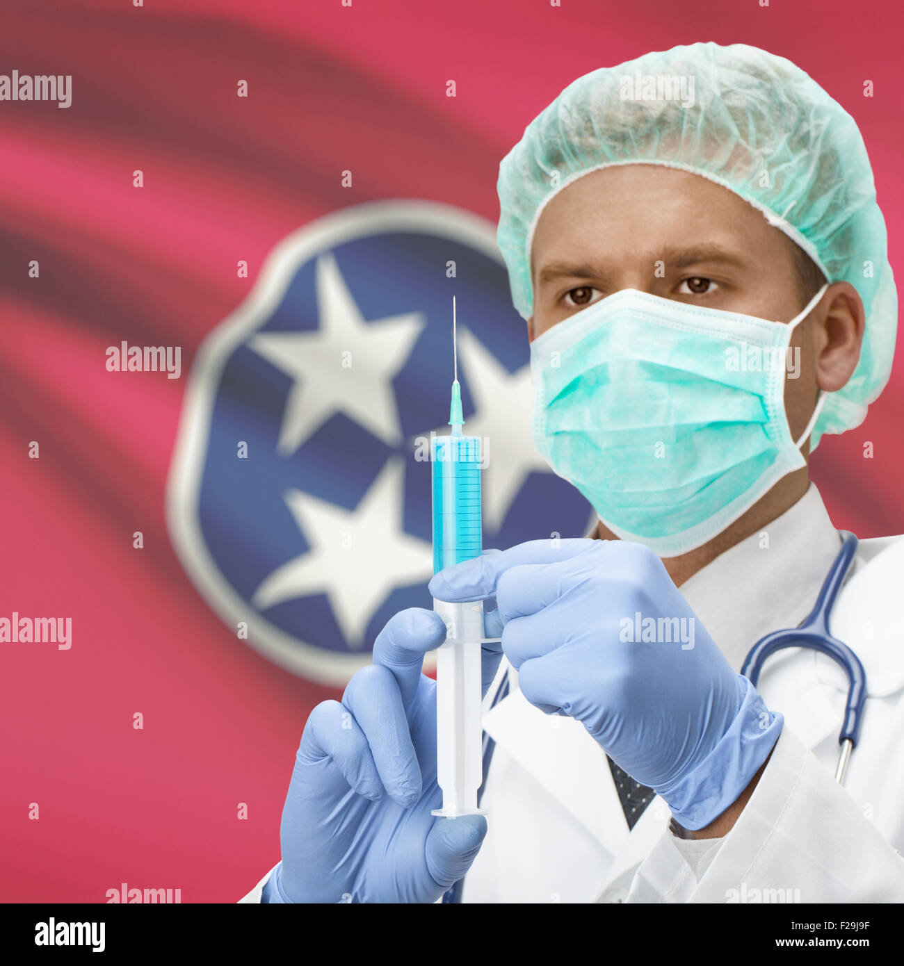 Doctor with syringe in hands and USA states flags on background series ...