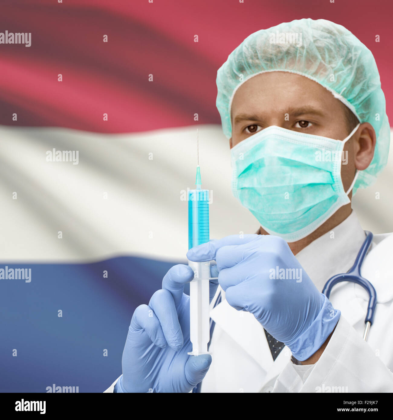Doctor with syringe in hands and flag on background series ...