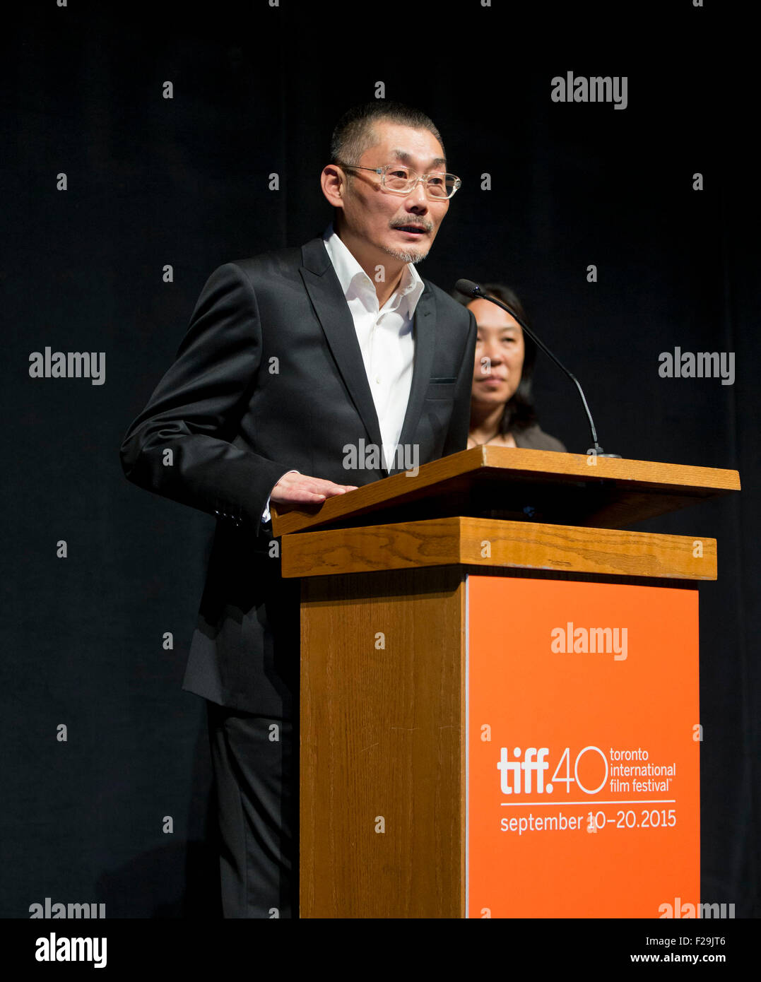 Toronto, Canada. 14th Sep, 2015. Director He Ping (L) introduces the ...