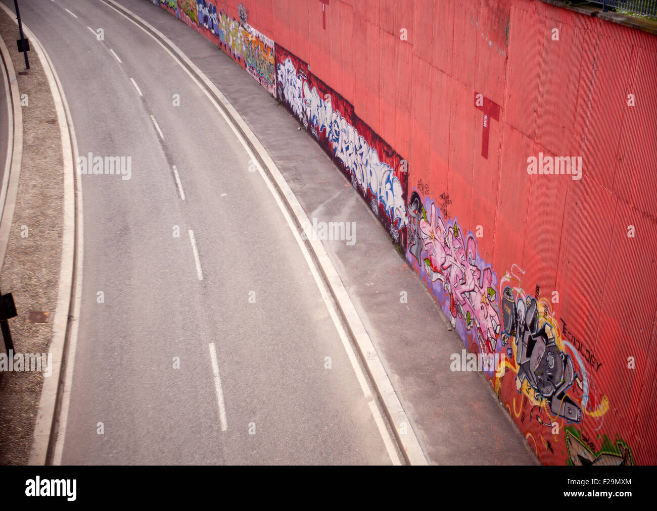 View of a road with graffiti on the wall Stock Photo - Alamy