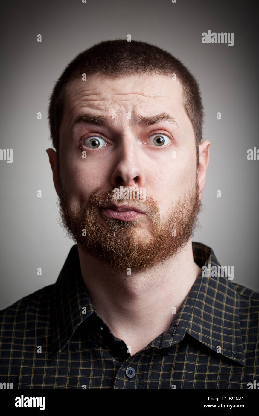 Face of funny amazed guy isolated on gray background Stock Photo - Alamy