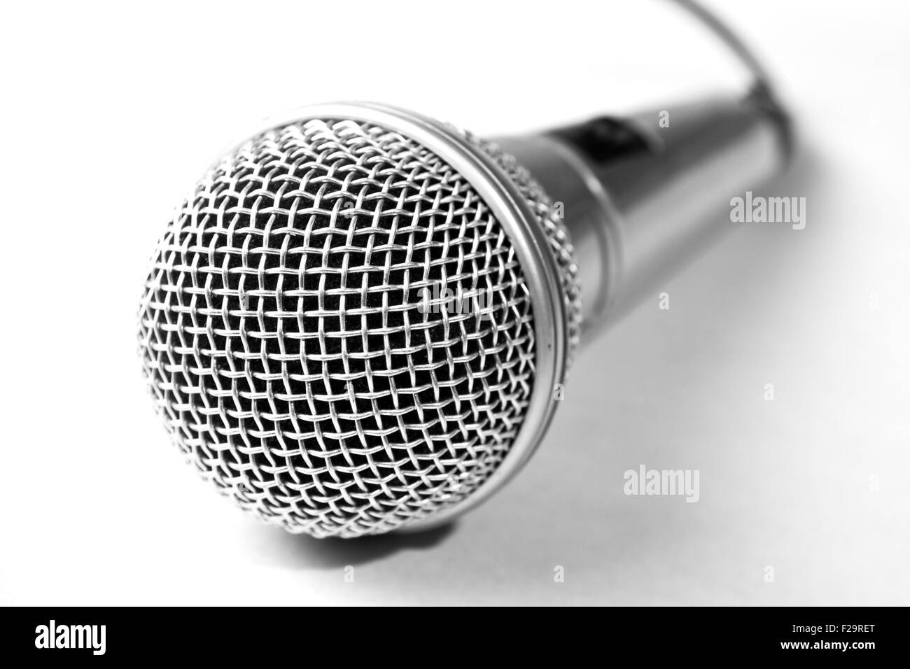 One silver microphone on white background Stock Photo - Alamy