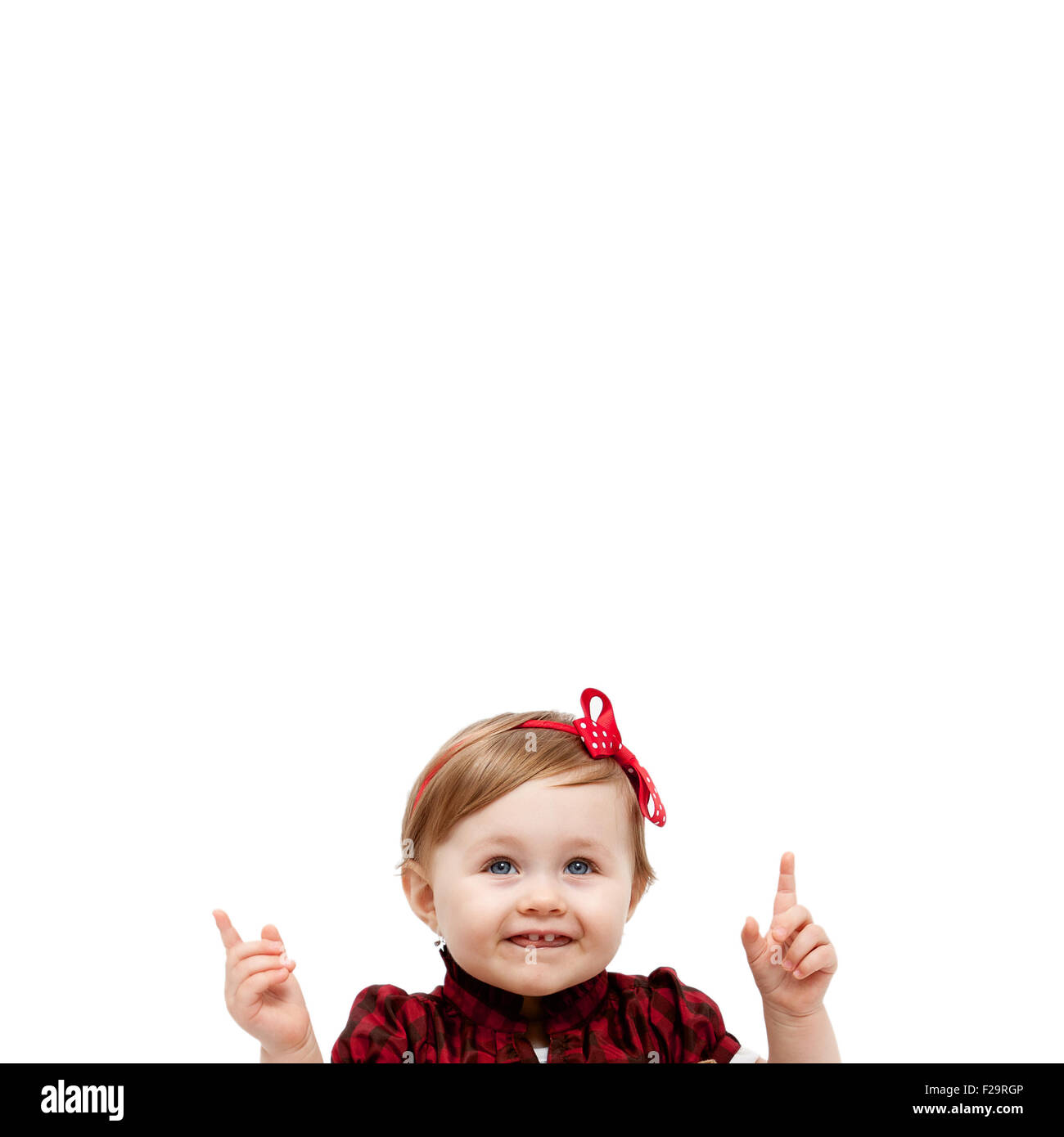 Isolated happy baby girl pointing up and above Stock Photo - Alamy