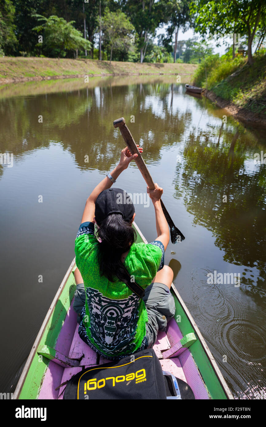 Woman rowing wooden canoe on canal Stock Photo - Alamy