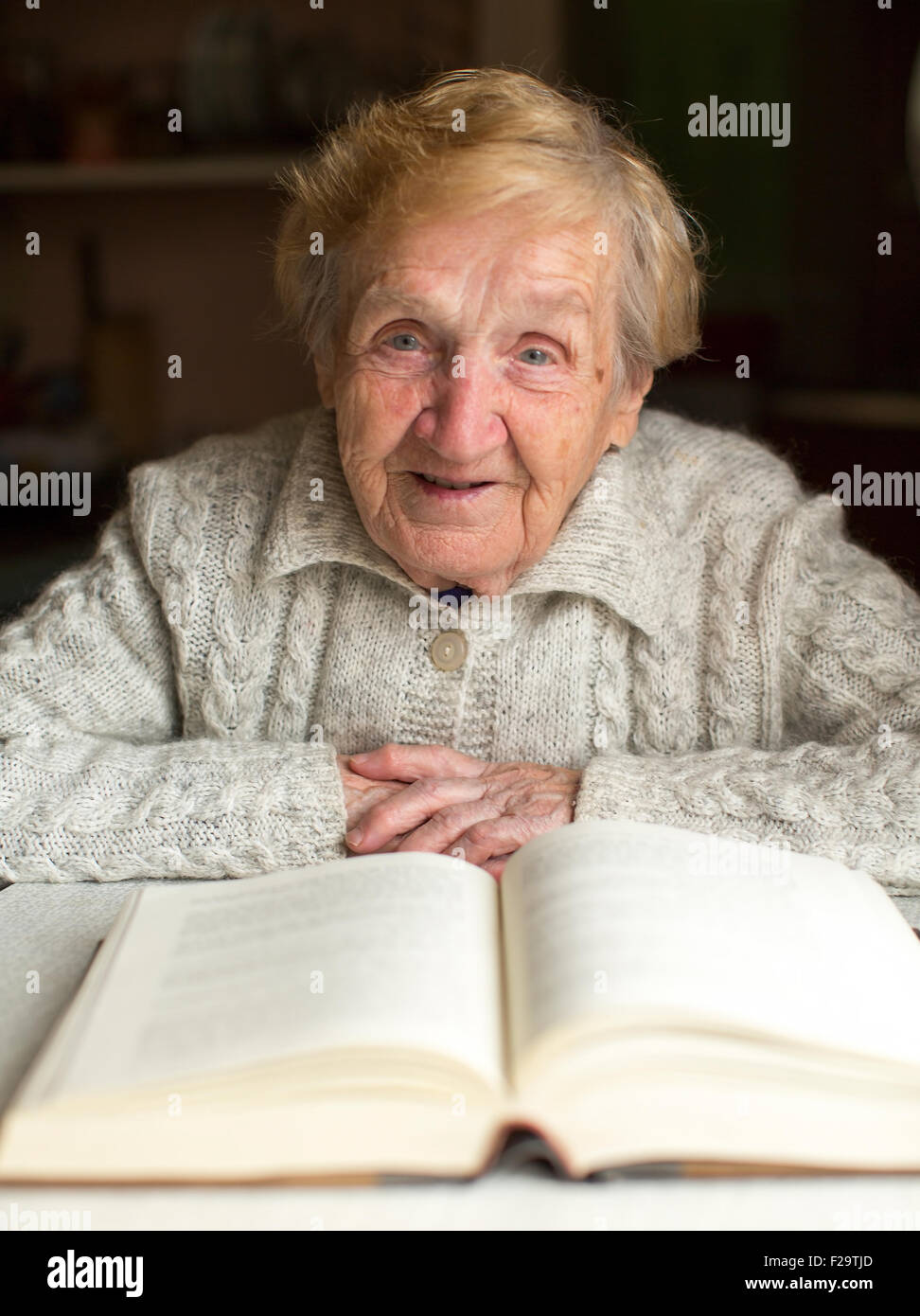Old woman with a book hi-res stock photography and images - Alamy