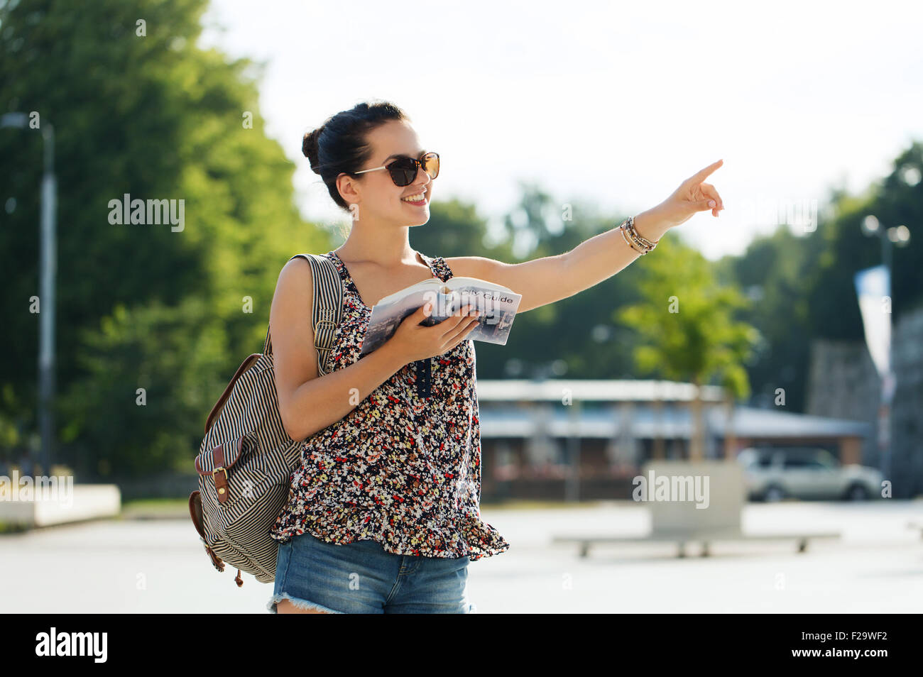 happy teenage girl with guidebook and backpack Stock Photo - Alamy