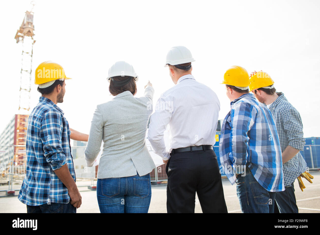 group of builders and architects at building site Stock Photo - Alamy