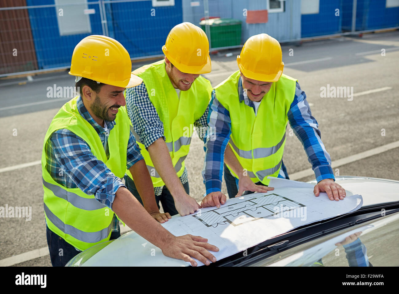 close up of builders with blueprint on car hood Stock Photo - Alamy