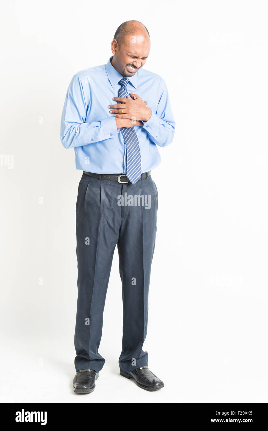 Full length Indian business man heartache, pressing on chest with ...