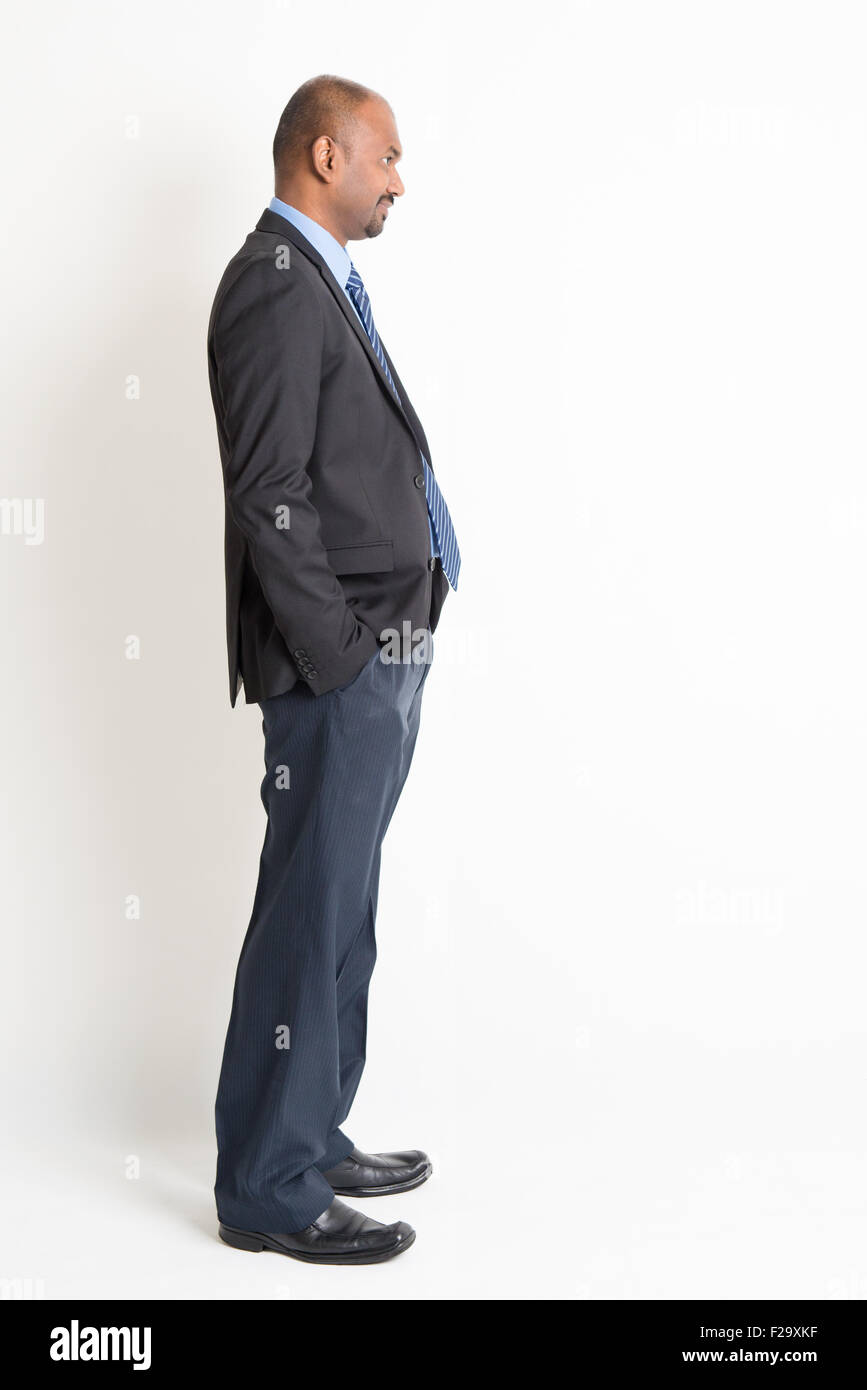 Side view full body mature Indian business man looking forward ...