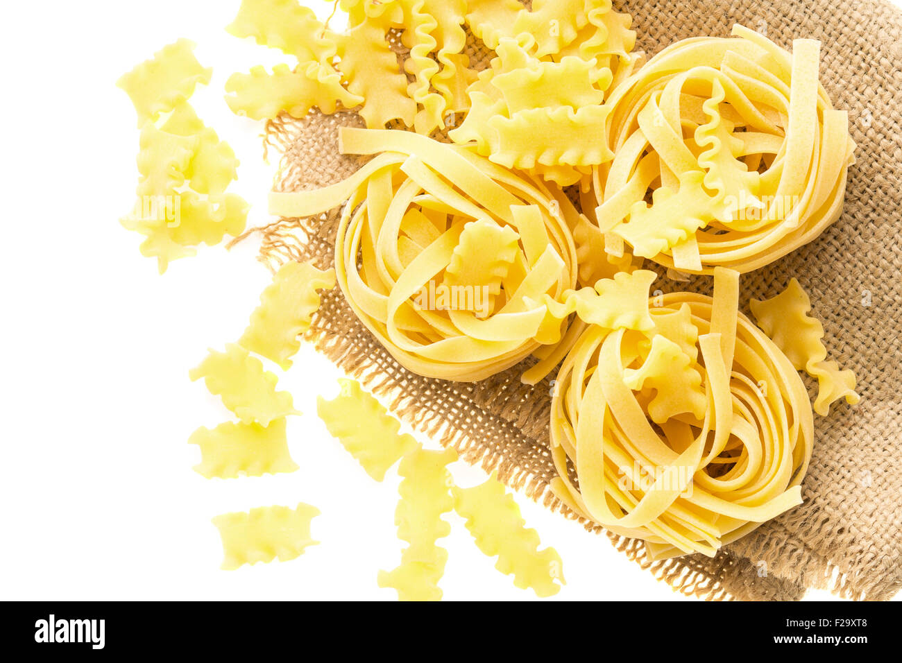 Italian pasta noodle nest on piece of sack on white background Stock ...