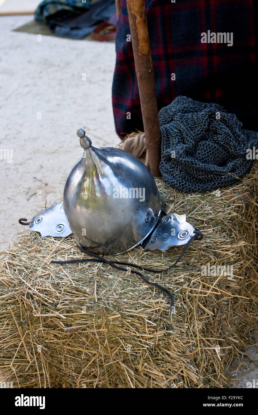 Helmet on a bales of hay Stock Photo - Alamy