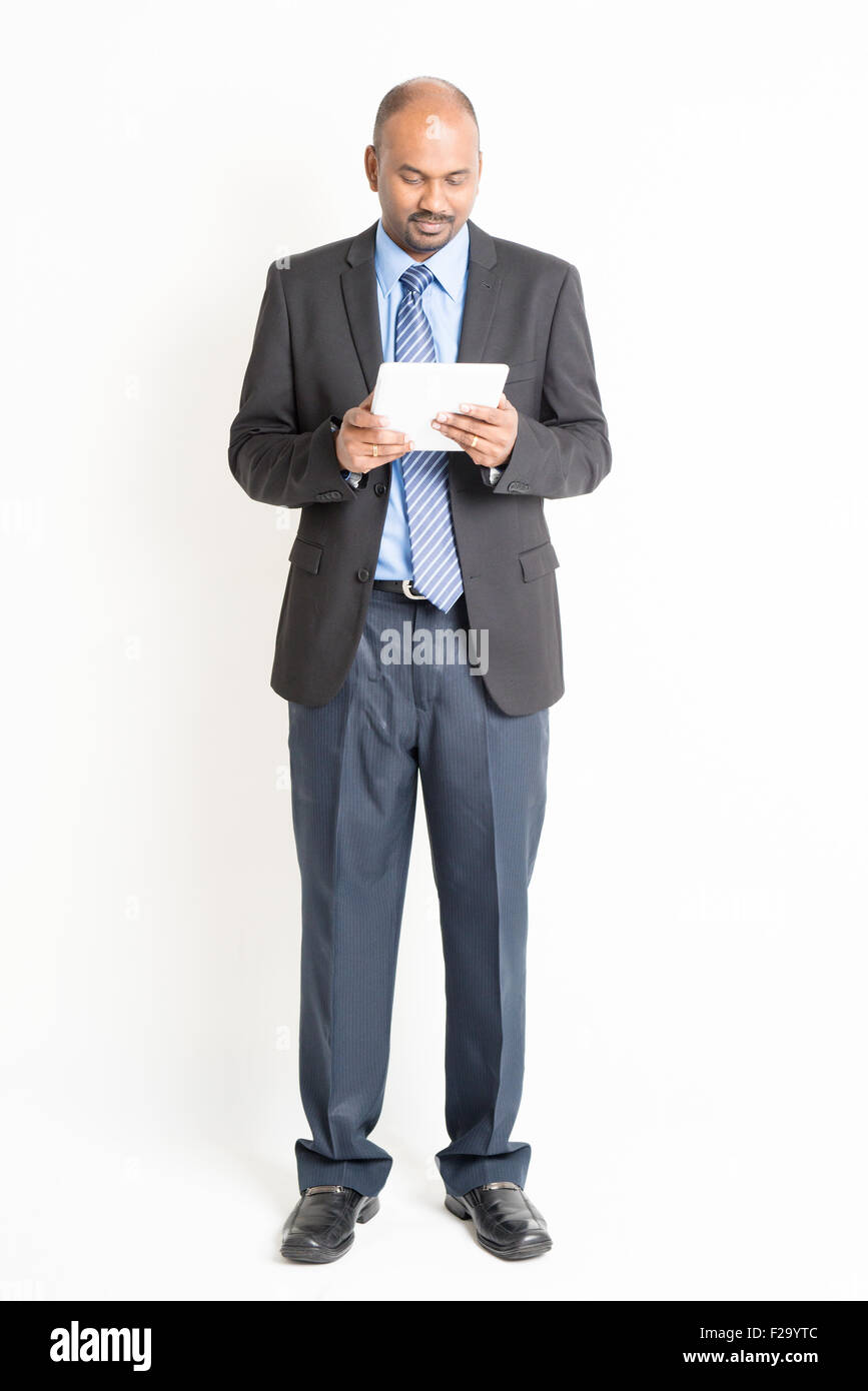 Full body Asian Indian businessman using digital tablet computer ...
