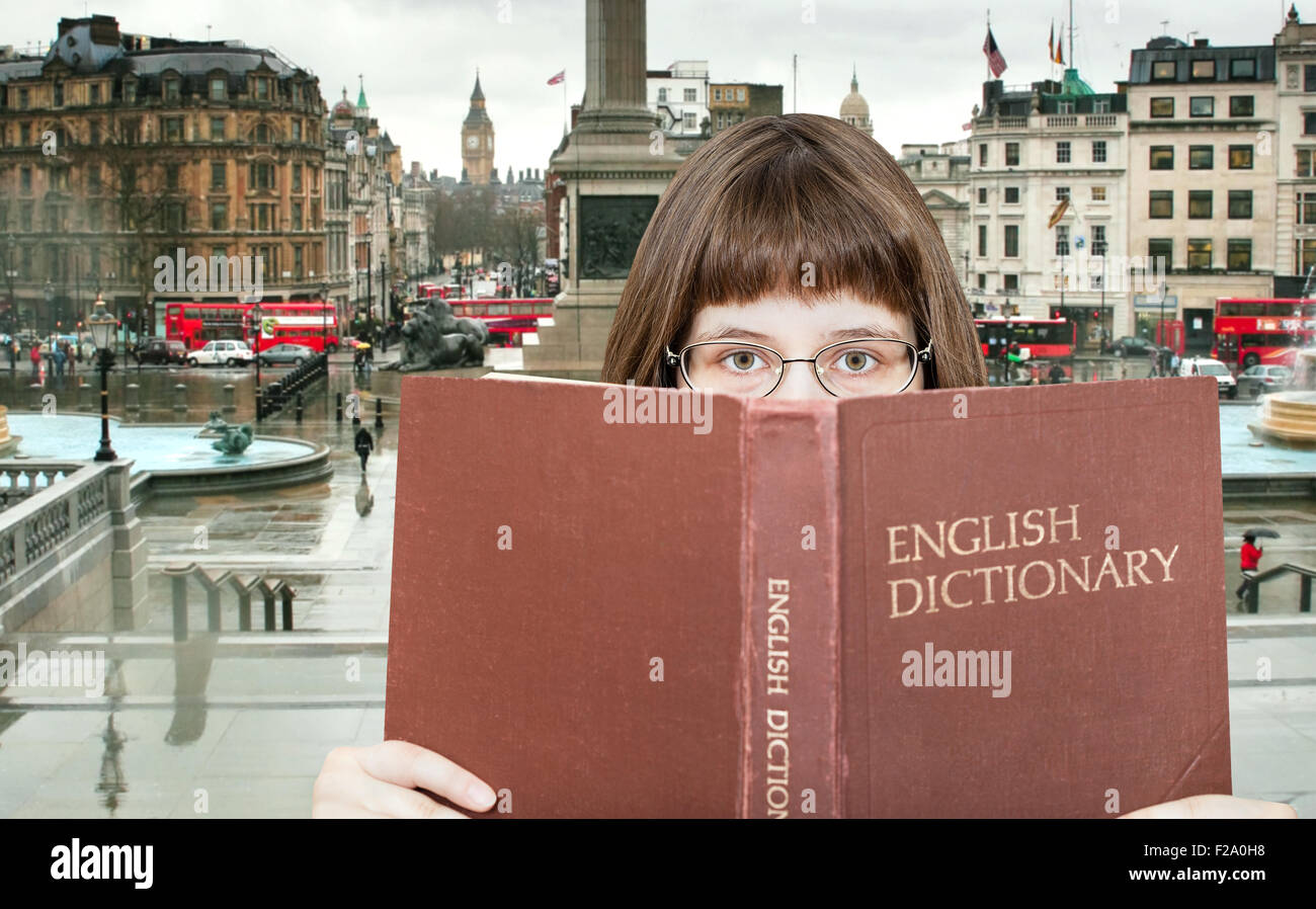 girl with spectacles looks over English Dictionary book and Trafalgar ...