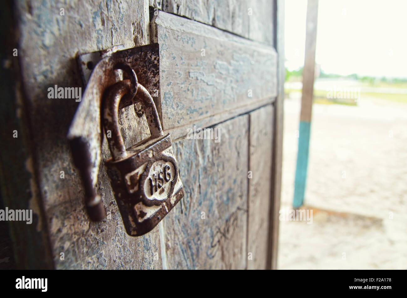 Hanging old padlock on wooden door Stock Photo - Alamy