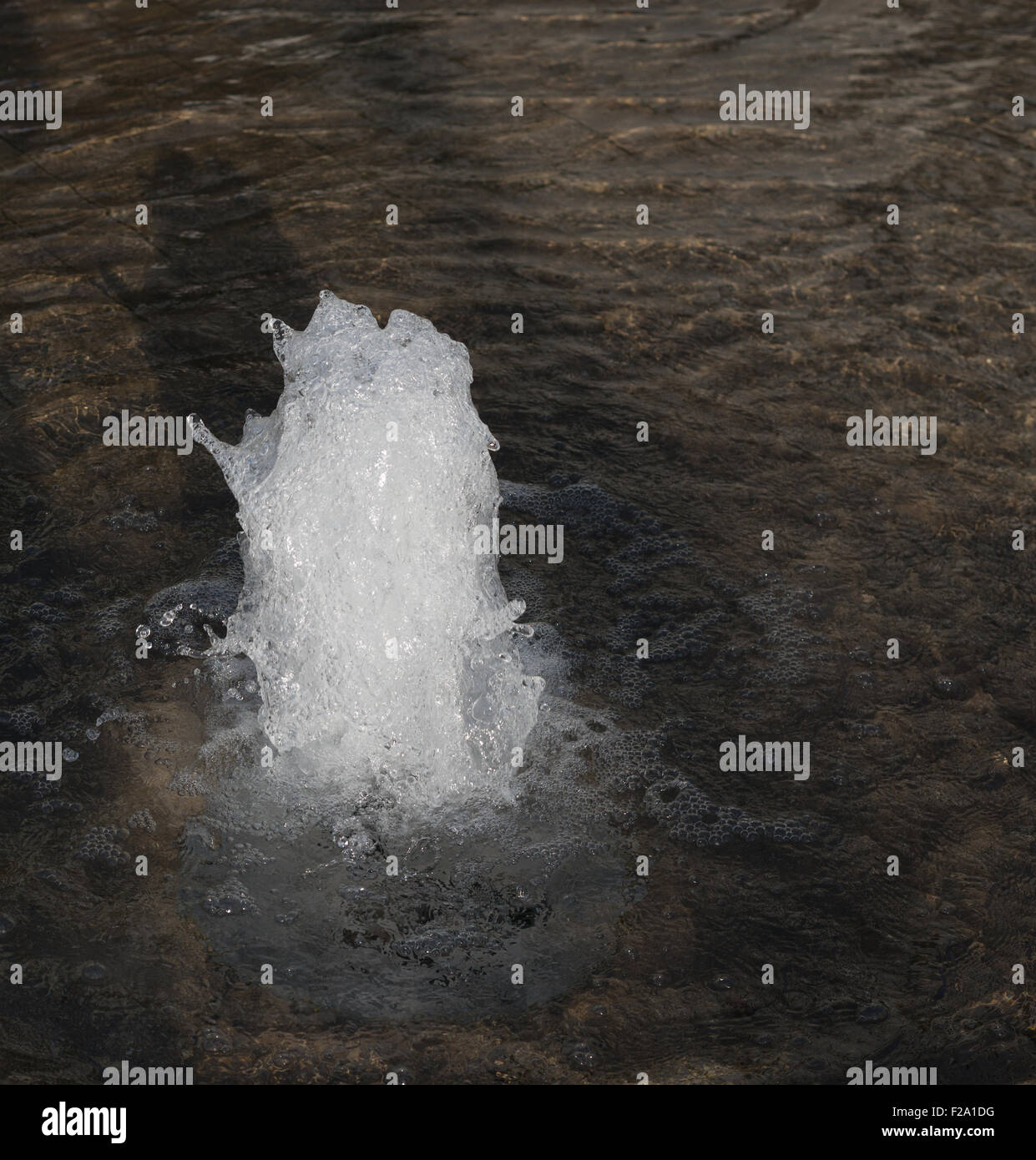 Small geyser in clear sea Stock Photo - Alamy