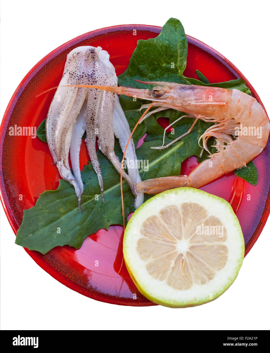 Shrimp, cuttlefish and lemon inside a red saucer Stock Photo - Alamy