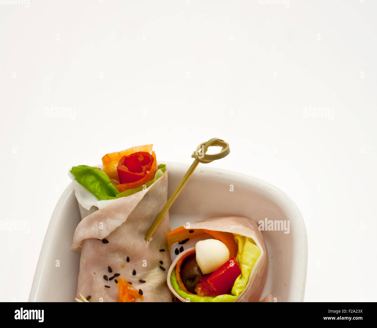 Appetizer with ham inside a saucer on a white background Stock Photo ...