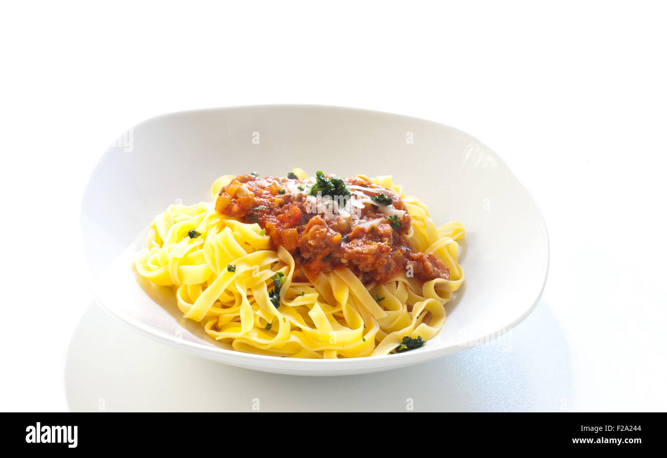 Italian pasta with ragout sauce on white background Stock Photo - Alamy