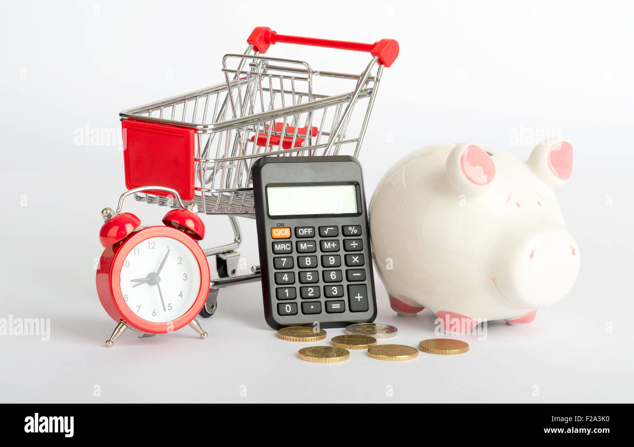 Shopping cart with coins Stock Photo - Alamy