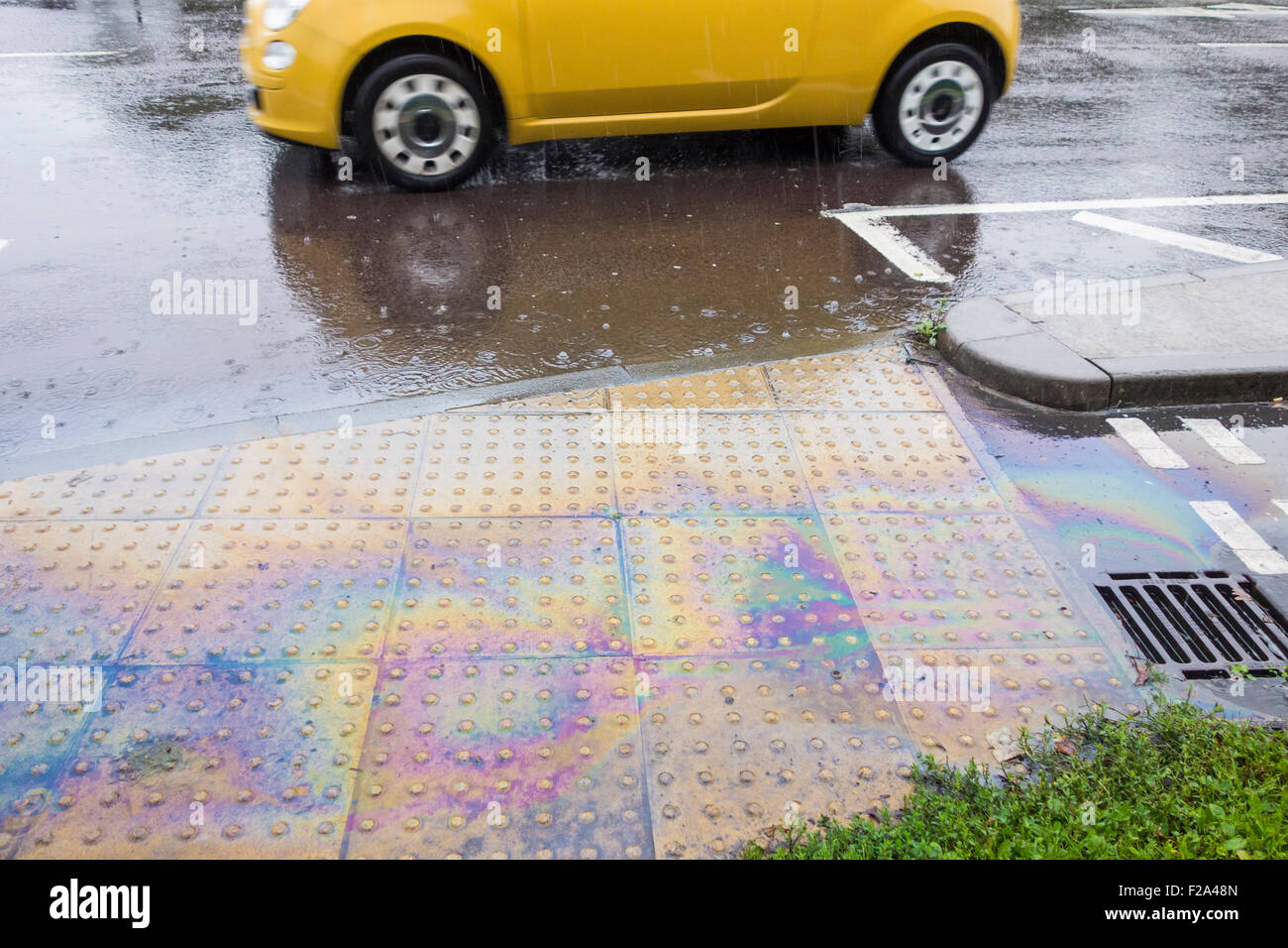 Fuel spill as drain overflows during heavy rain. UK Stock Photo - Alamy