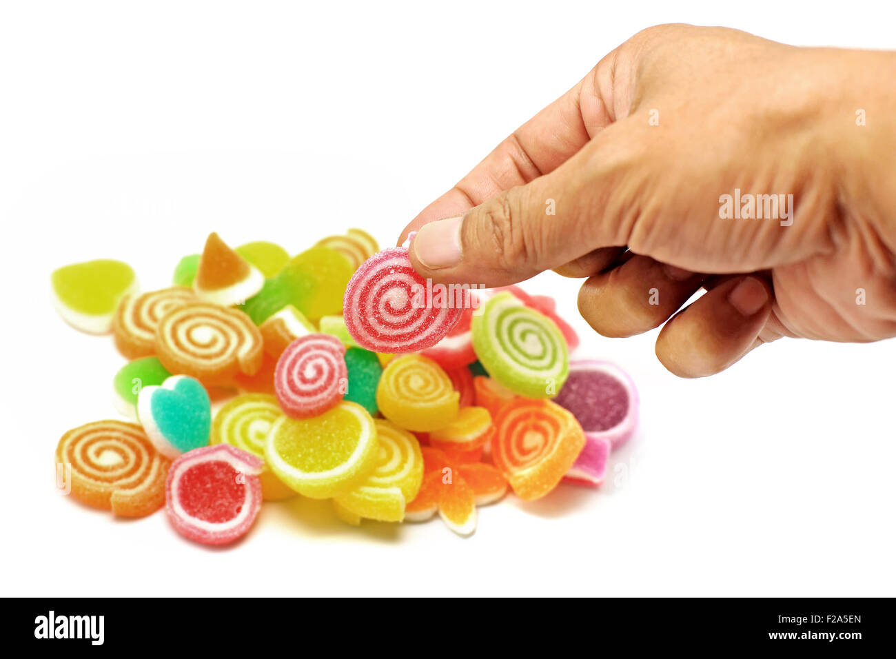 human hand pick up jelly sweet candy isolated on white background Stock ...