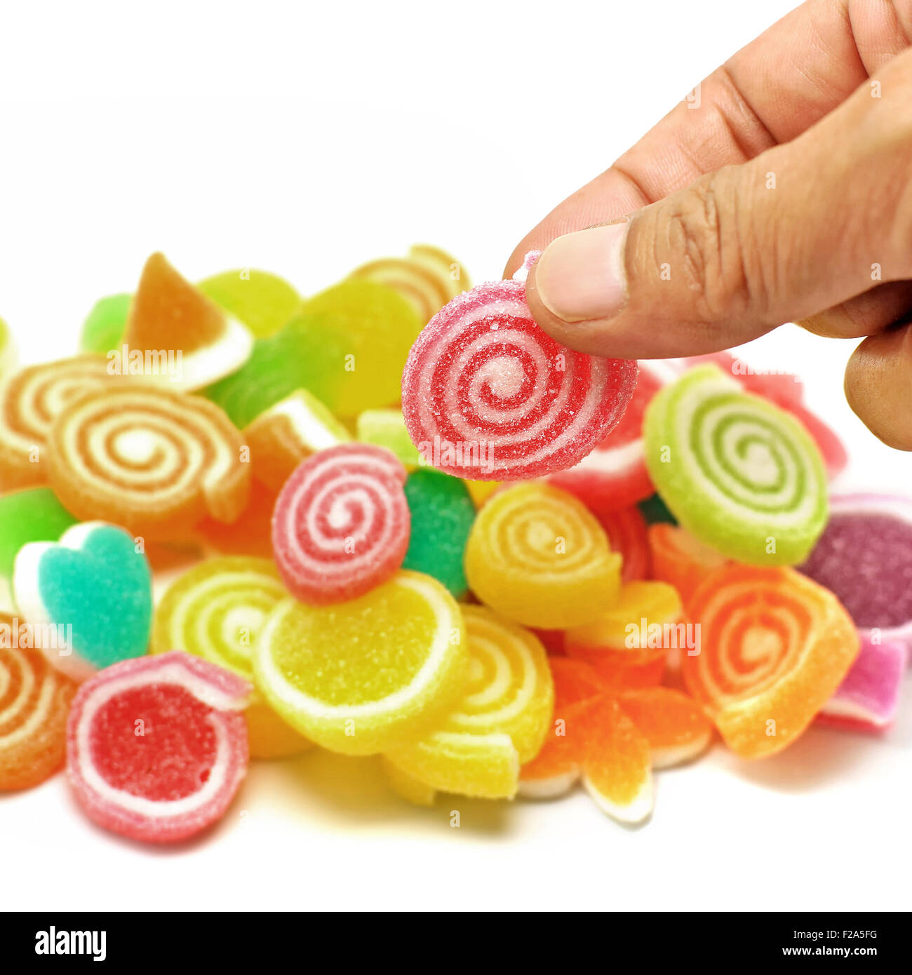 human hand pick up jelly sweet candy isolated on white background Stock ...