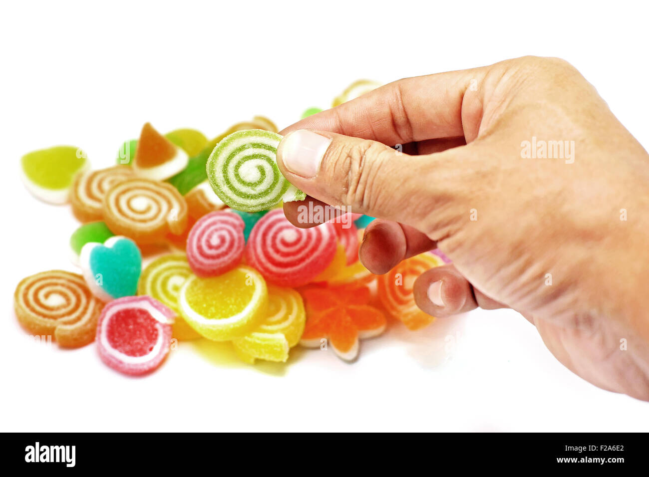 human hand pick up jelly sweet candy isolated on white background Stock ...