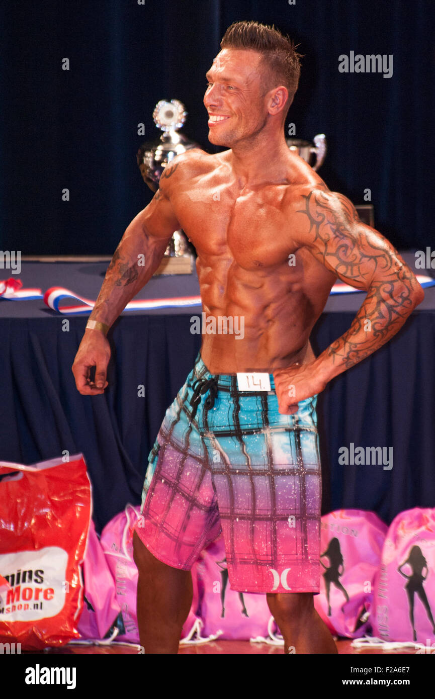 SCHIEDAM, THE NETHERLANDS - APRIL 26, 2015. Male bodybuilder shows his ...