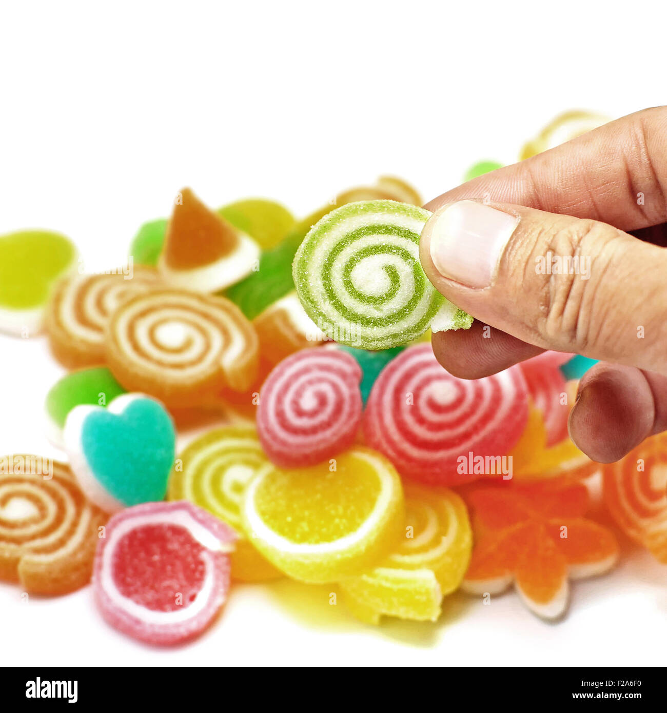 human hand pick up jelly sweet candy isolated on white background Stock ...