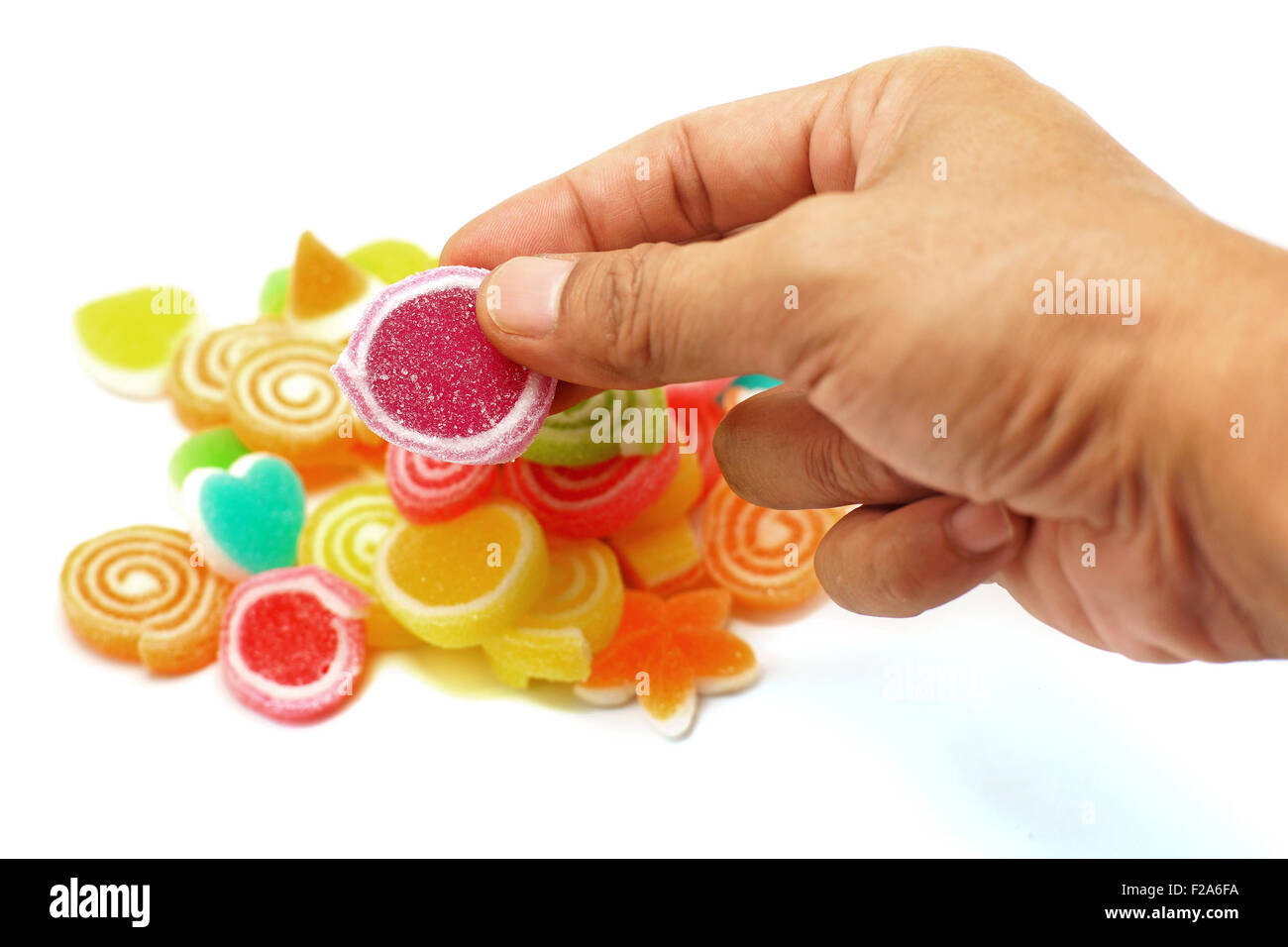 human hand pick up jelly sweet candy isolated on white background Stock ...