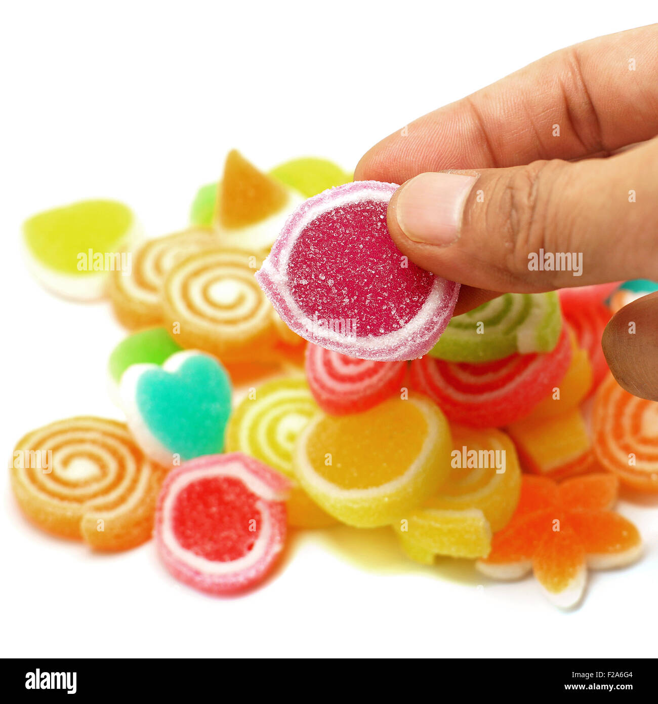 human hand pick up jelly sweet candy isolated on white background Stock ...