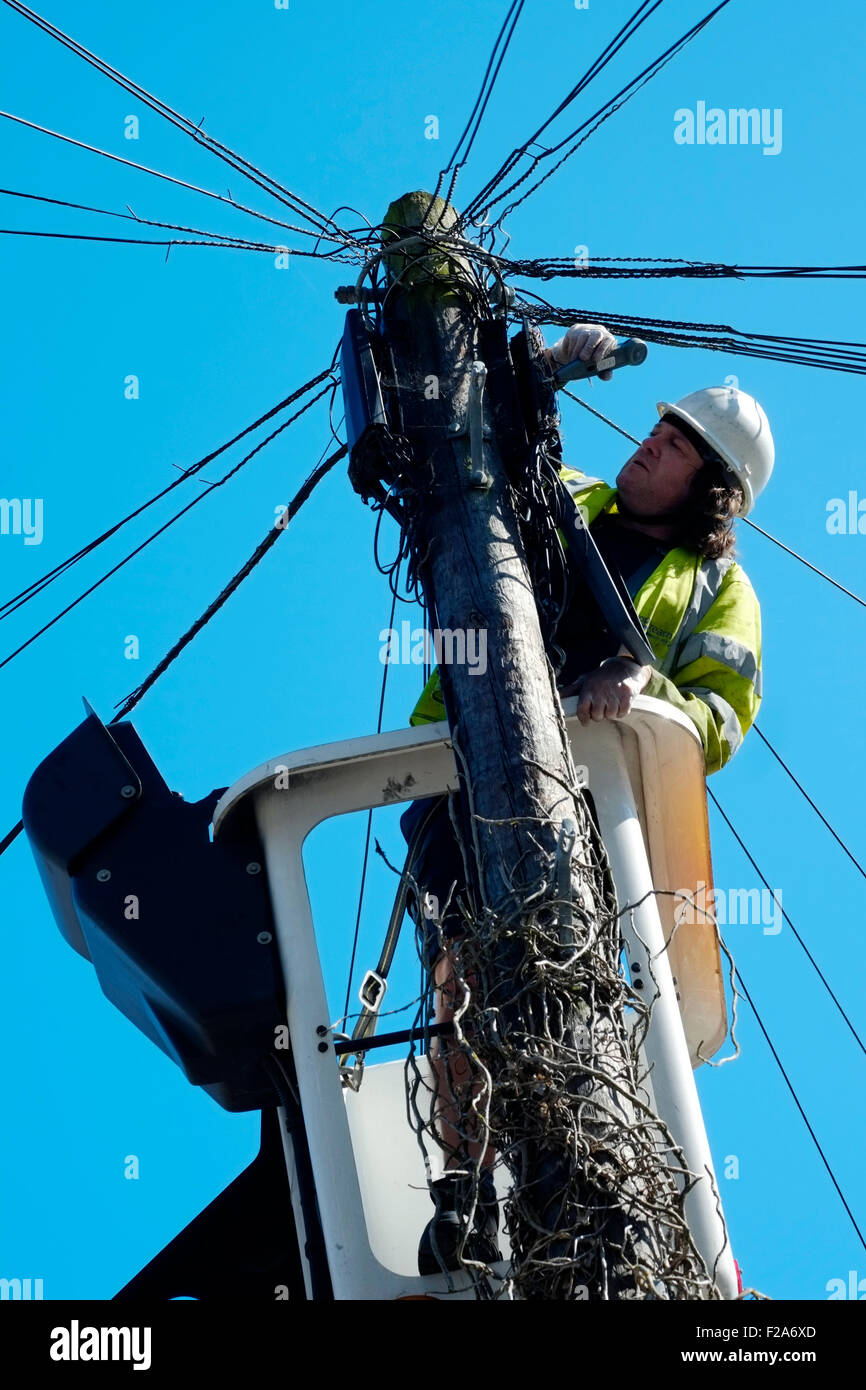 telecoms engineer working at the top of a telephone pole england uk ...