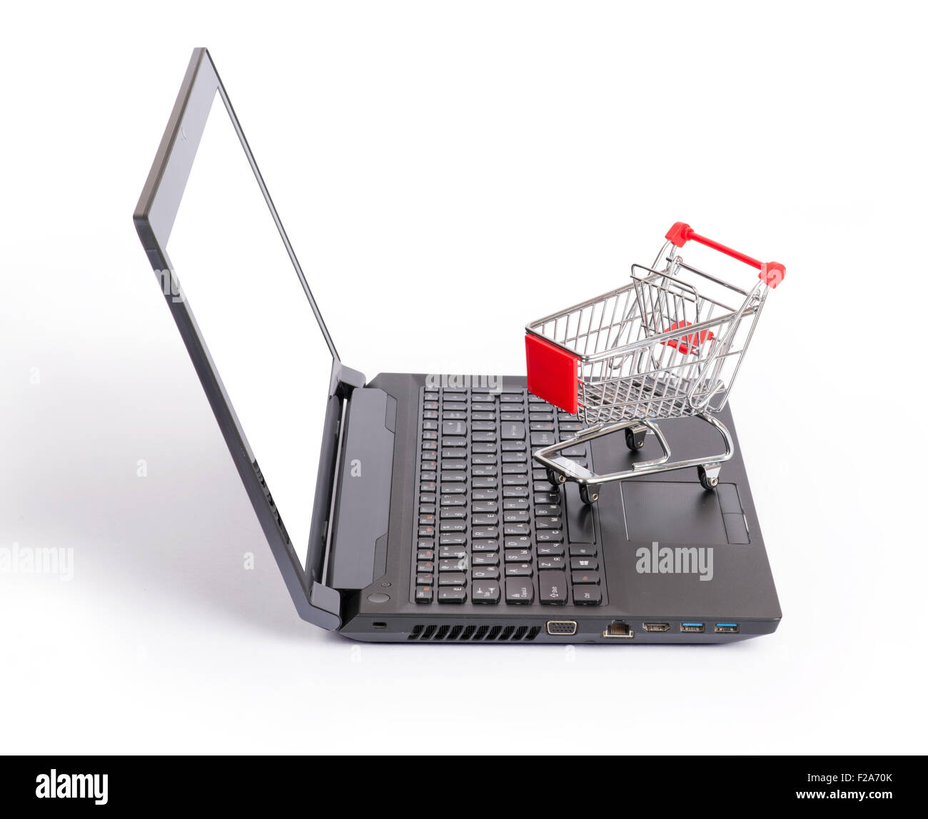 Shopping cart on laptop, side view Stock Photo - Alamy