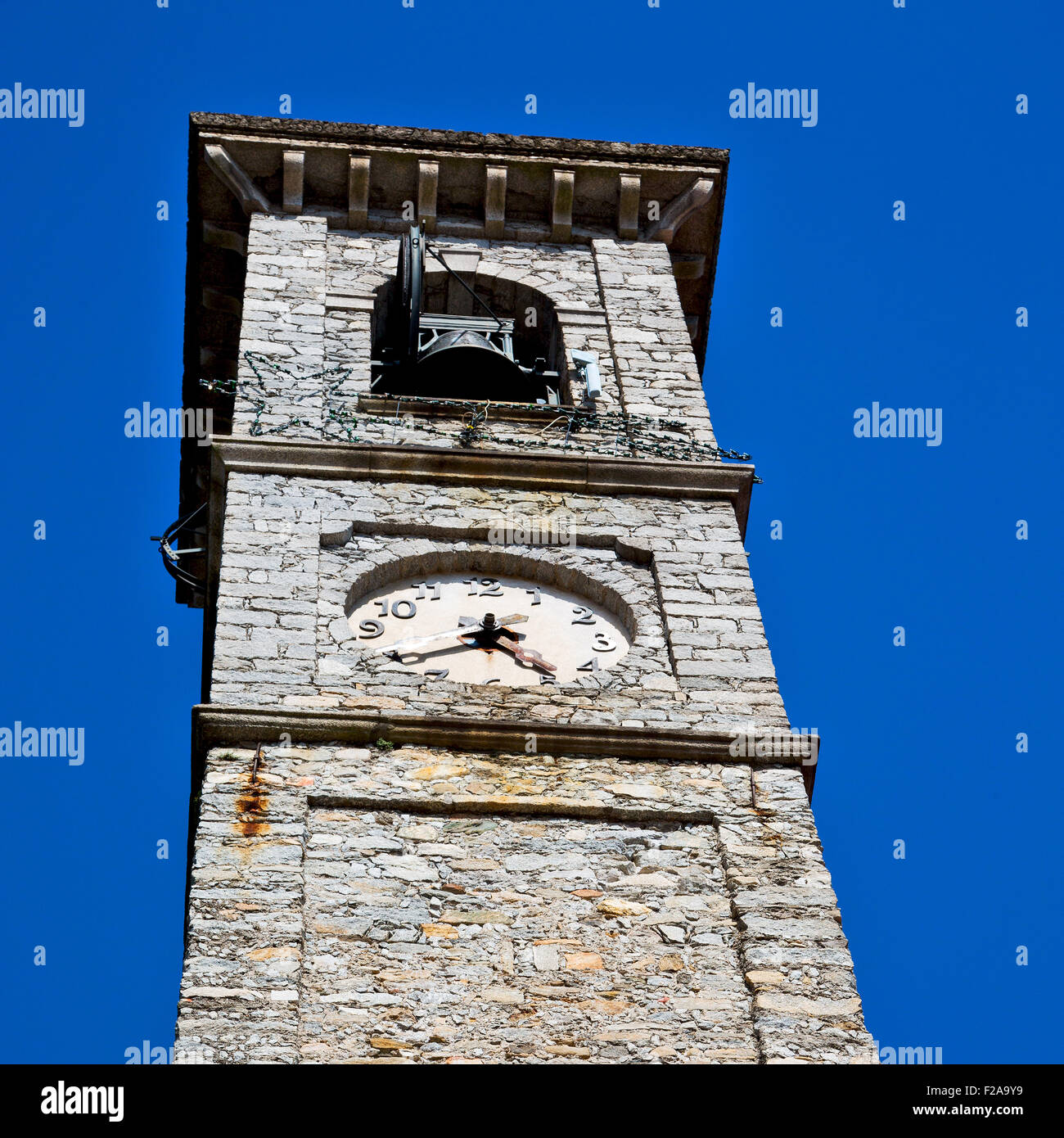 ancien clock tower in italy europe old stone and bell Stock Photo - Alamy