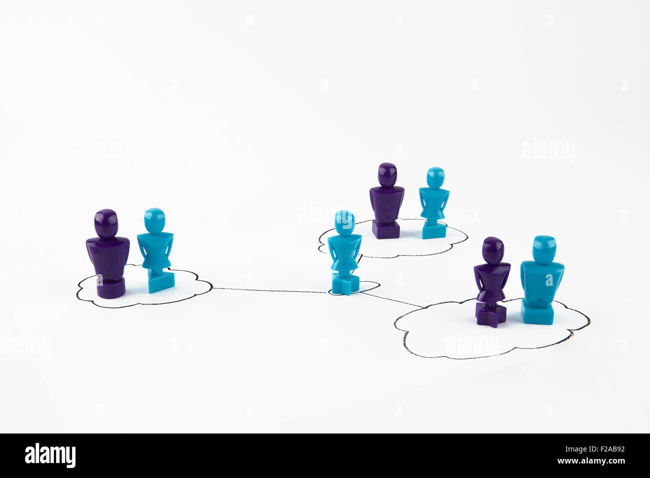 Faceless male and female figurines situated on line graph representing ...