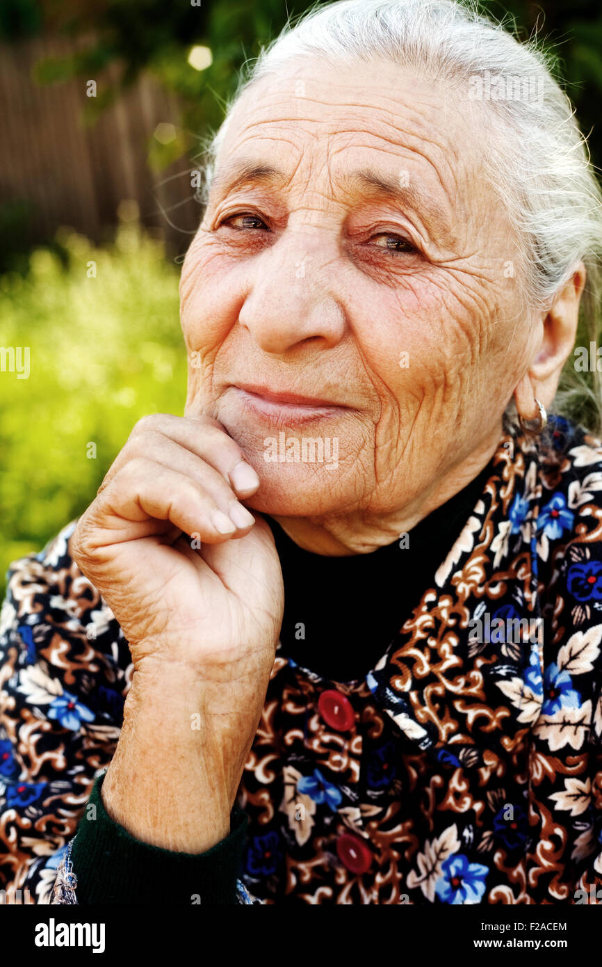 Smile of elegant content senior woman outdoor Stock Photo - Alamy