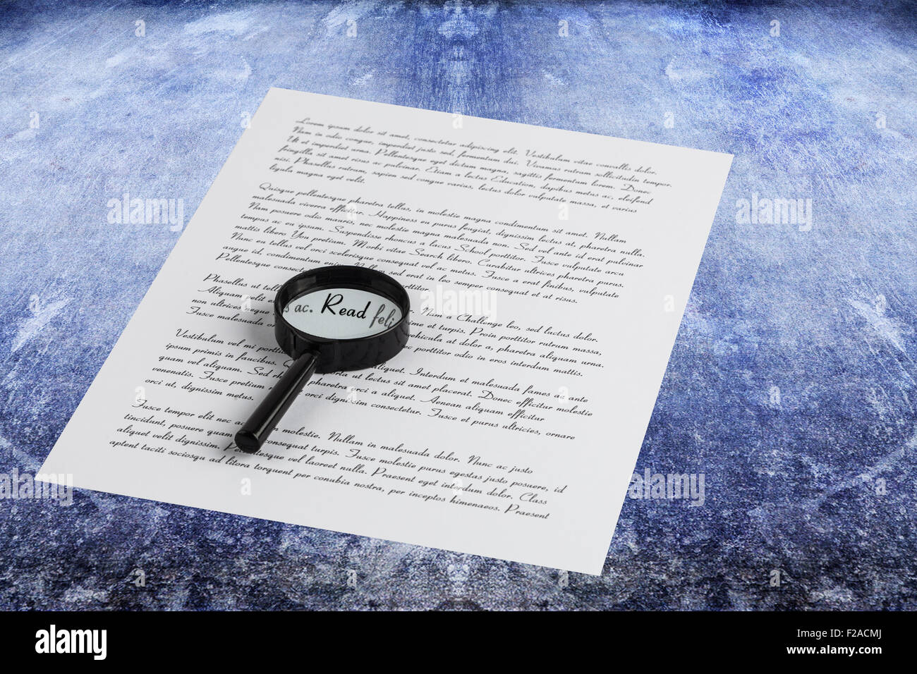 Magnifying glass enlarging the word Read on a page with printed text ...