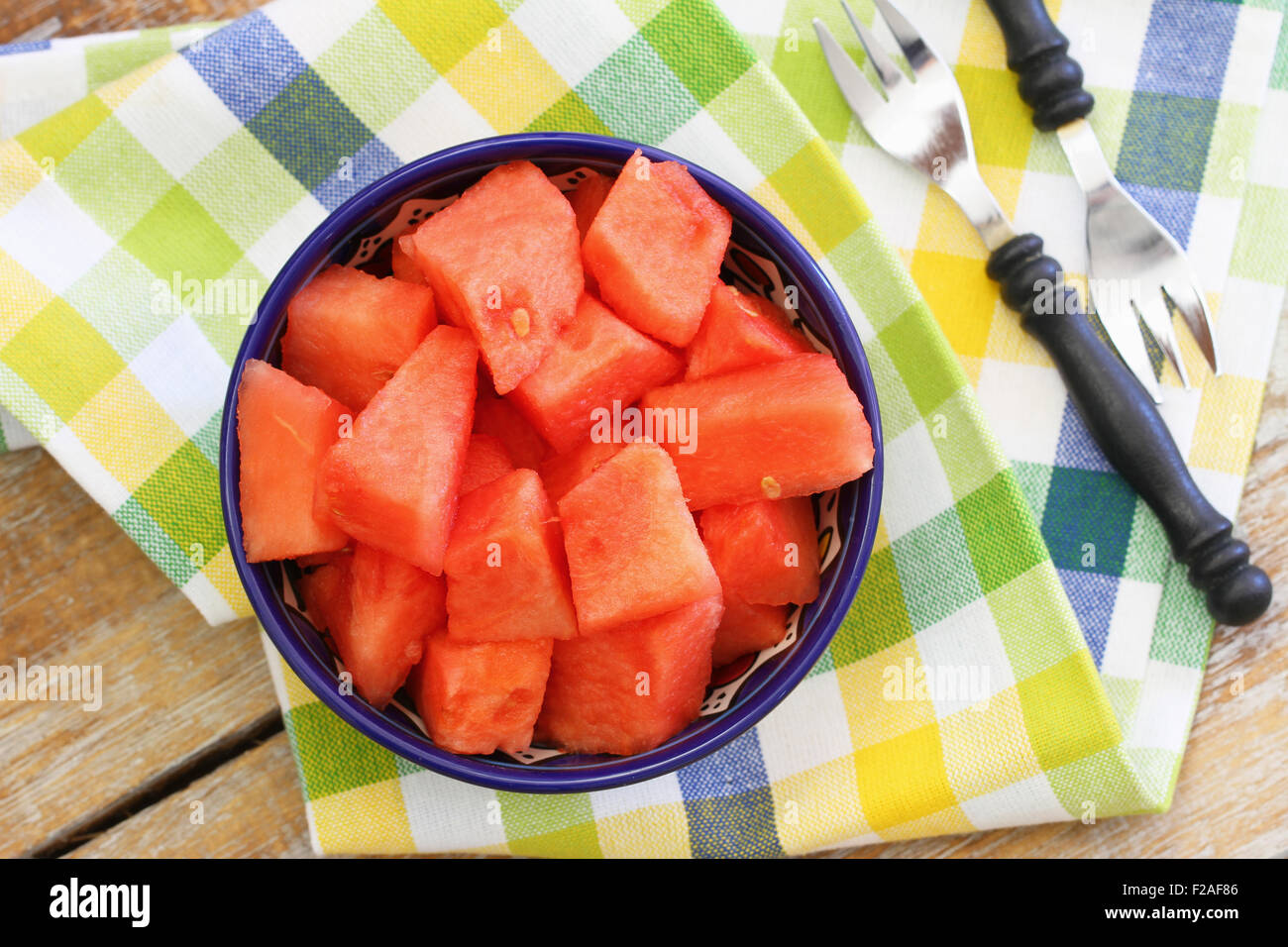 Watermelon cubes in bowl on checkered cloth Stock Photo - Alamy