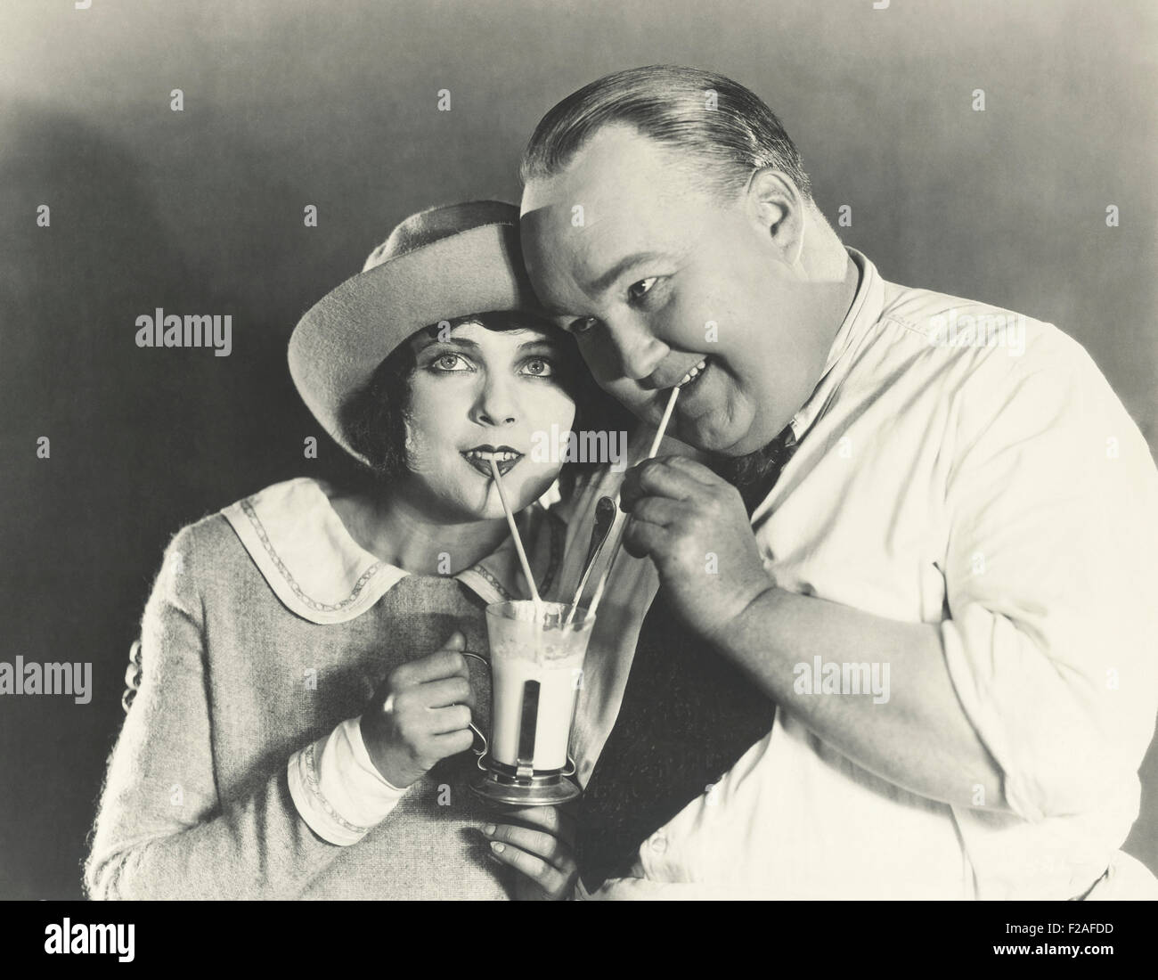 Young couple sharing milkshake hi-res stock photography and images - Alamy