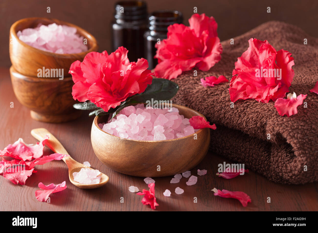 spa aromatherapy with azalea flowers and herbal salt on rustic dark ...
